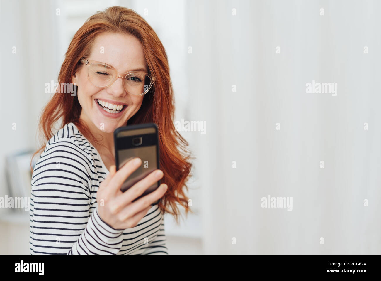 Cute Playful Young Redhead Woman Winking At The Camera With A Cheeky
