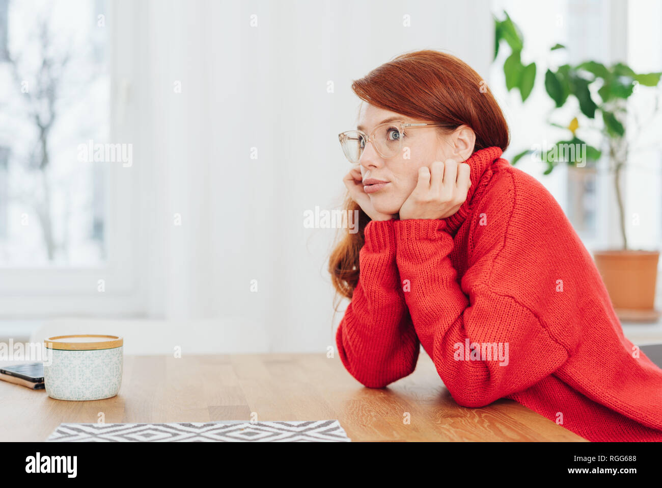 Young woman sitting dining table hi-res stock photography and images ...