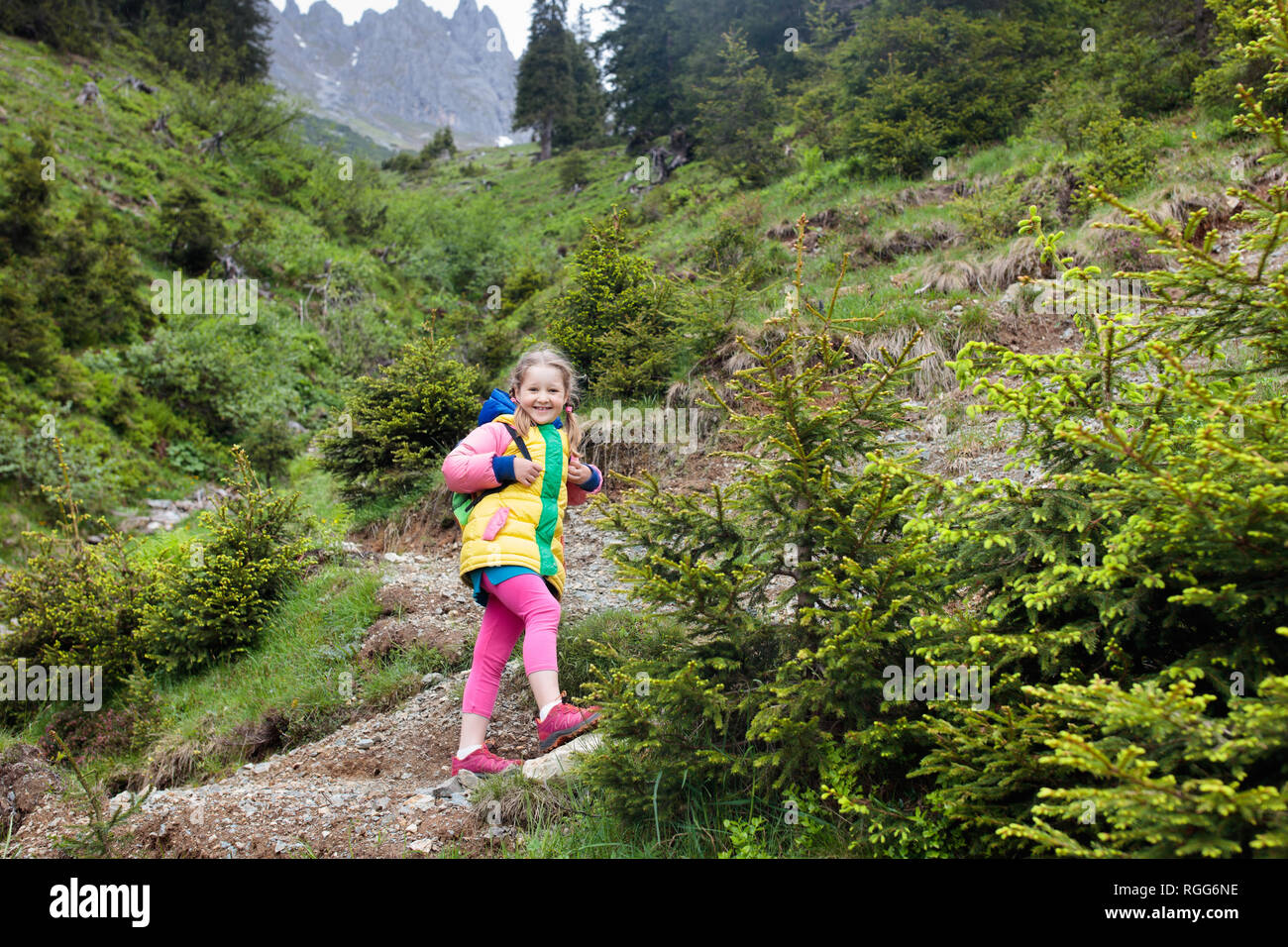 Children hiking in Alps mountains. Kids look at snow covered mountain ...