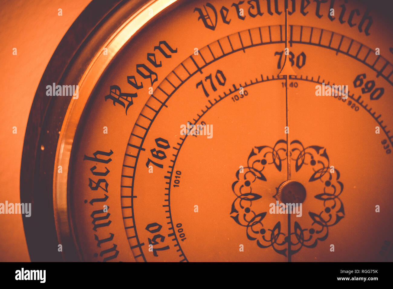 Old barometer dial close up with added orange filter Stock Photo - Alamy