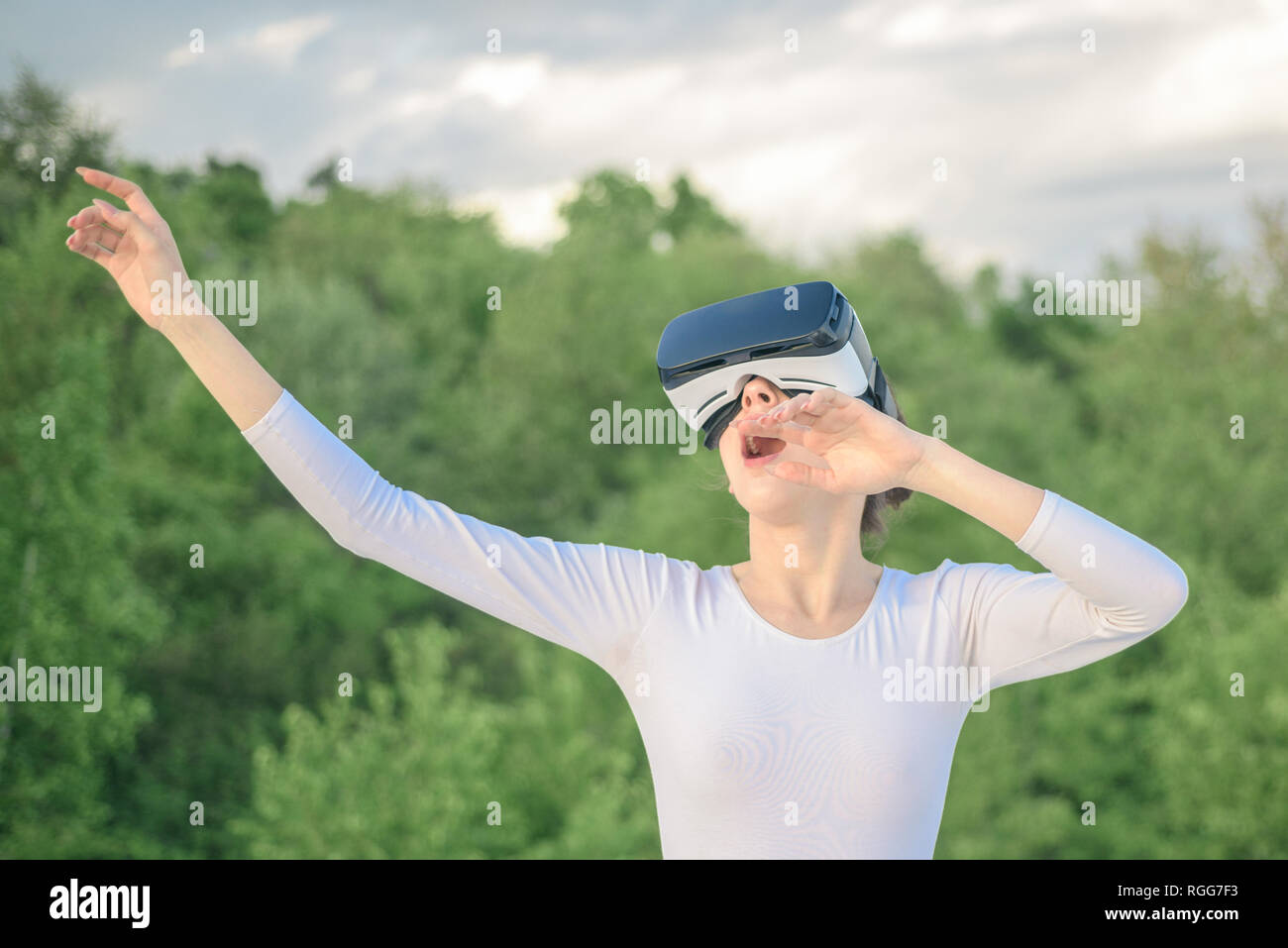 Enjoying new technology. Pretty girl in virtual reality headset. Cute ...