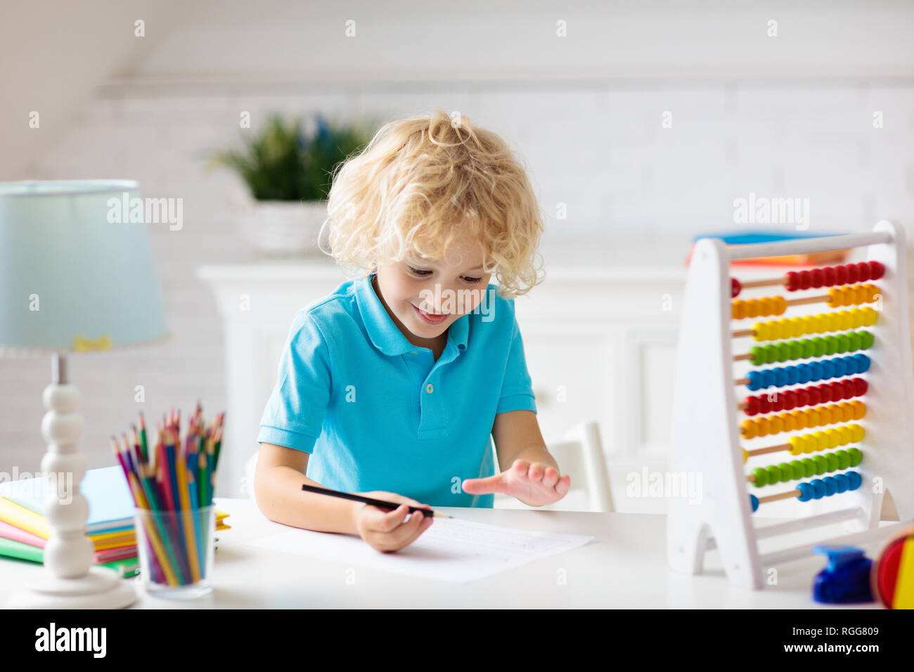 Child doing homework at home. Little boy with wooden colorful abacus ...