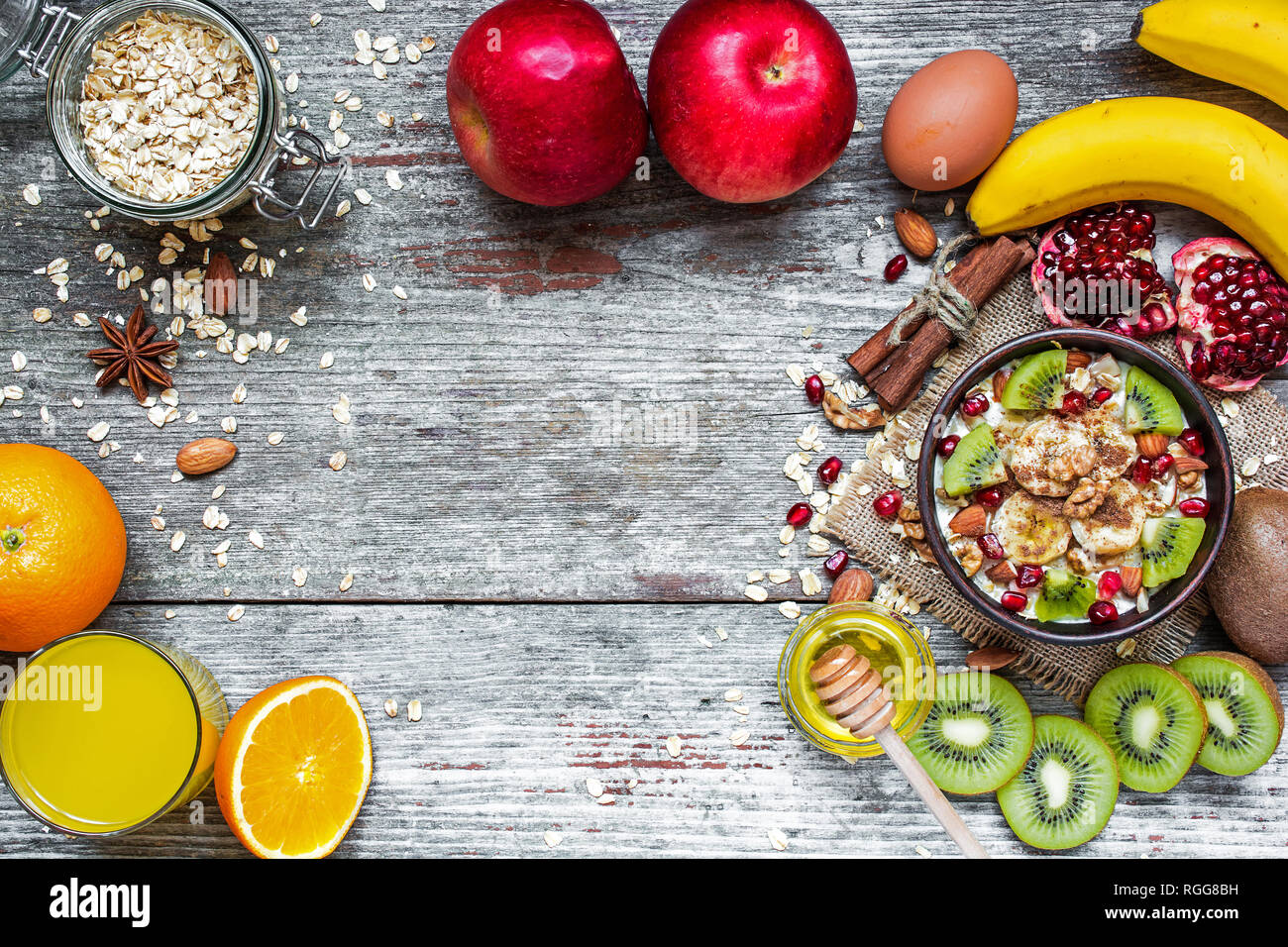 healthy breakfast with fruit oatmeal, fresh fruits, honey, egg, spices ...