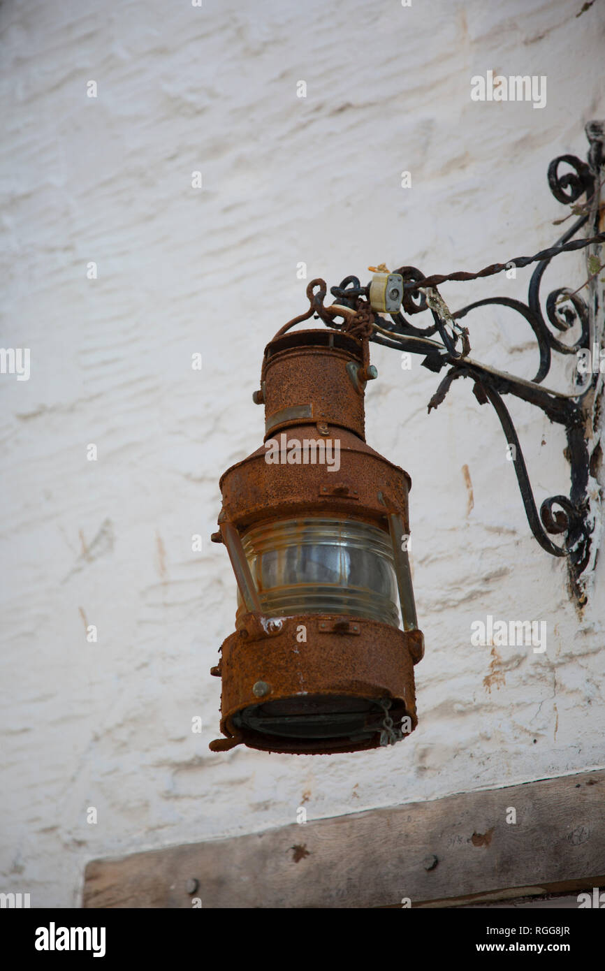 Rusty vintage lantern hanging from a house wall at the British seaside ...
