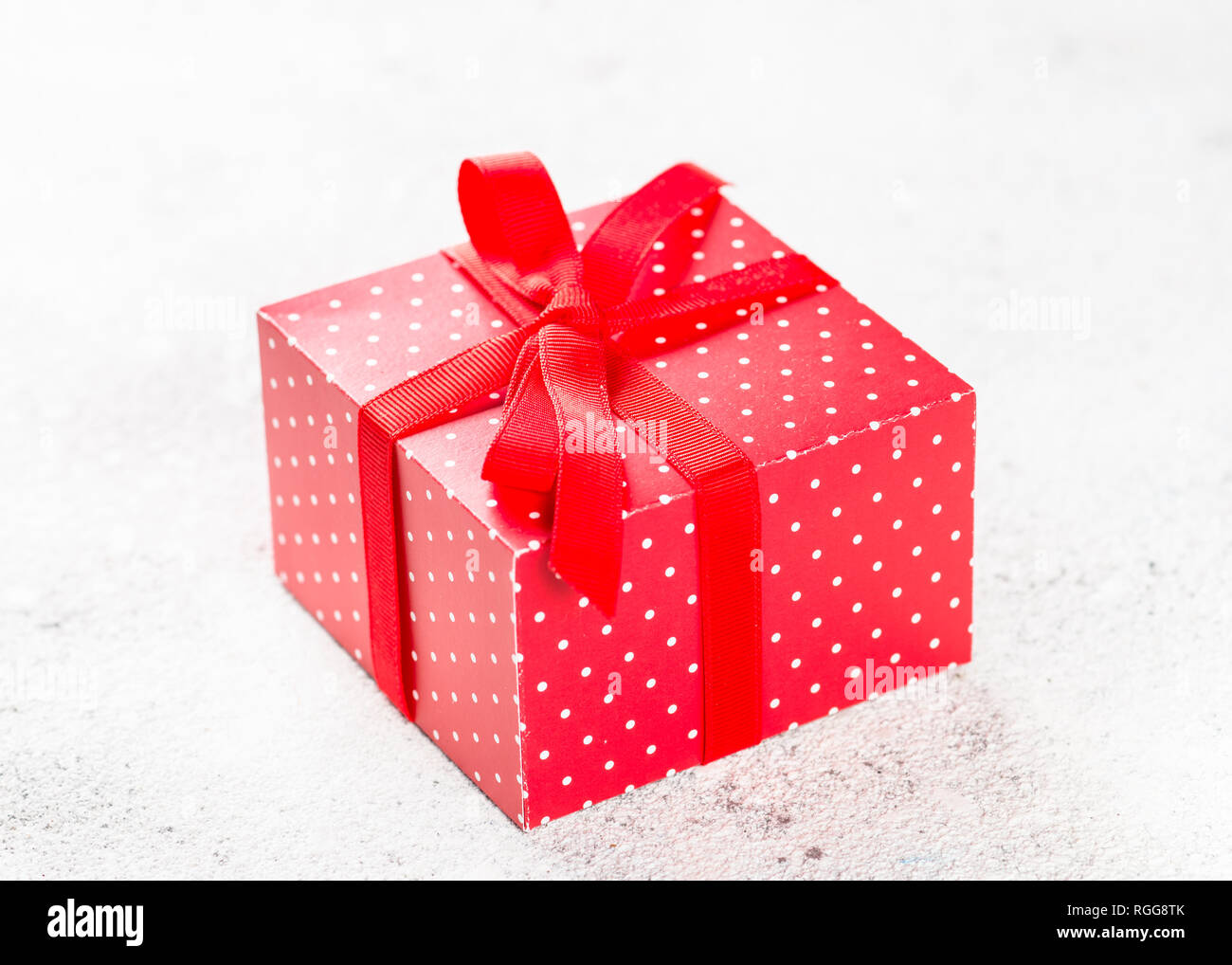Red present box with ribbon on white background Stock Photo - Alamy