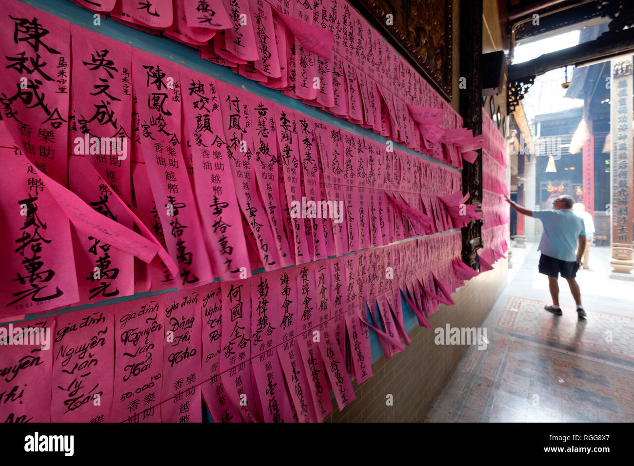 Pink paper prayer slips with the names of donatorsChua Ba Thien Hau ...