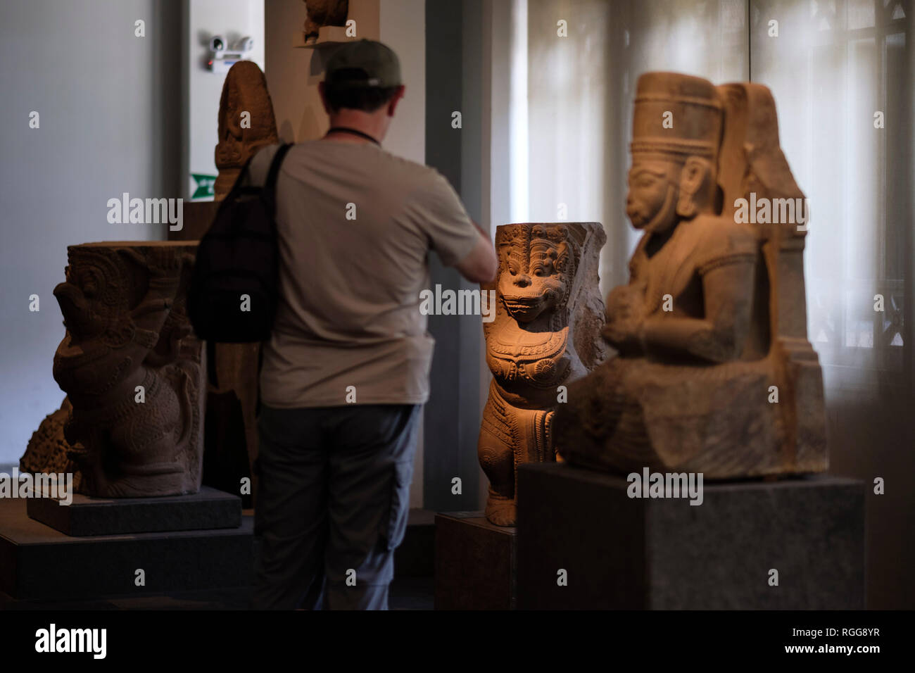 Tourist looking at Champa civilization stone sculptures at the History ...