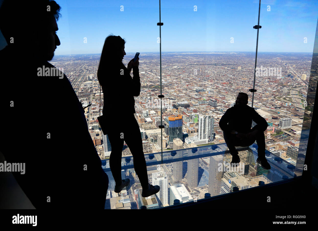 Tourists taking photo in "The Ledge" of the Skydeck observation deck on ...