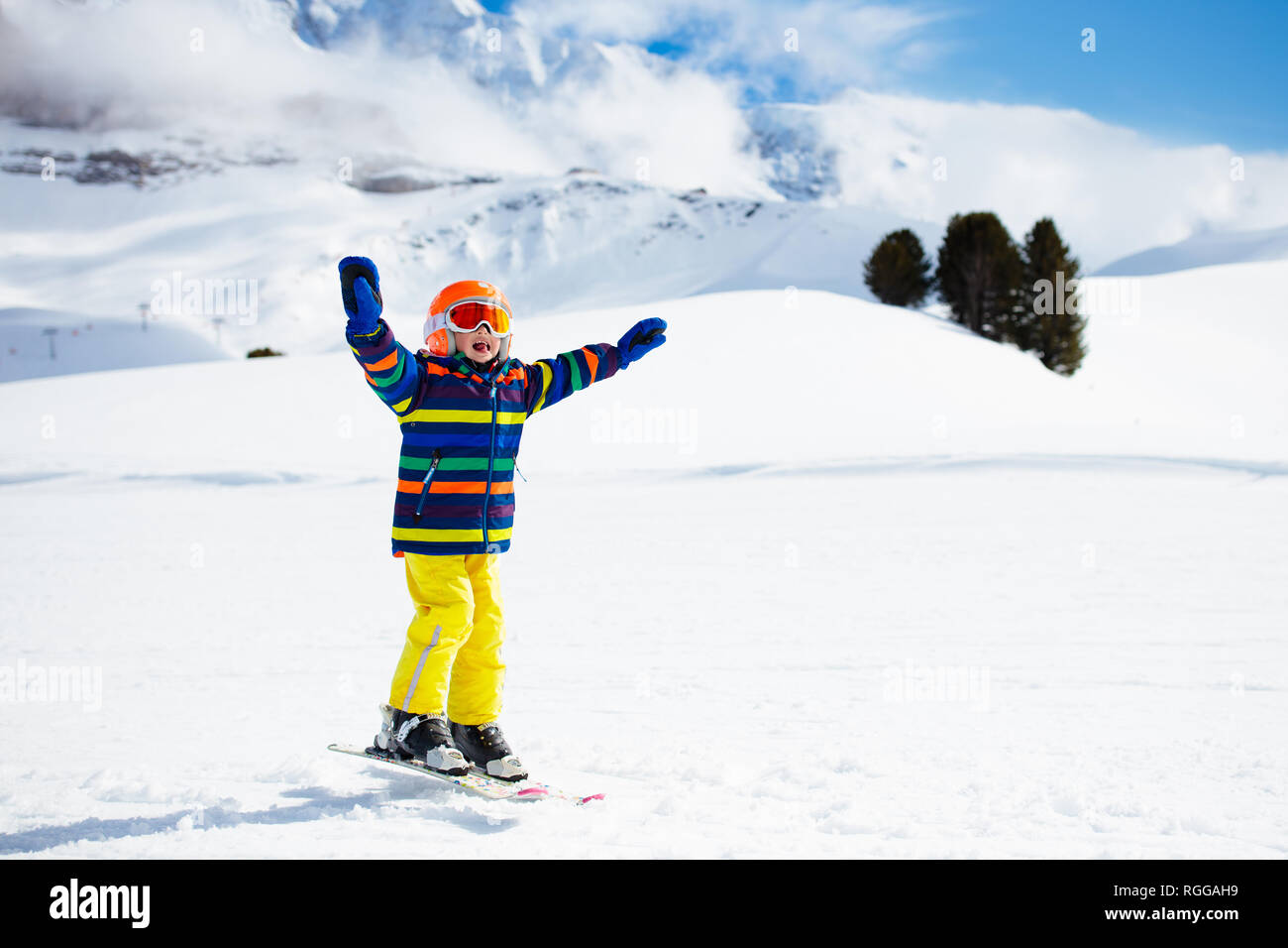 Child skiing in the mountains. Kid in ski school. Winter sport for kids ...