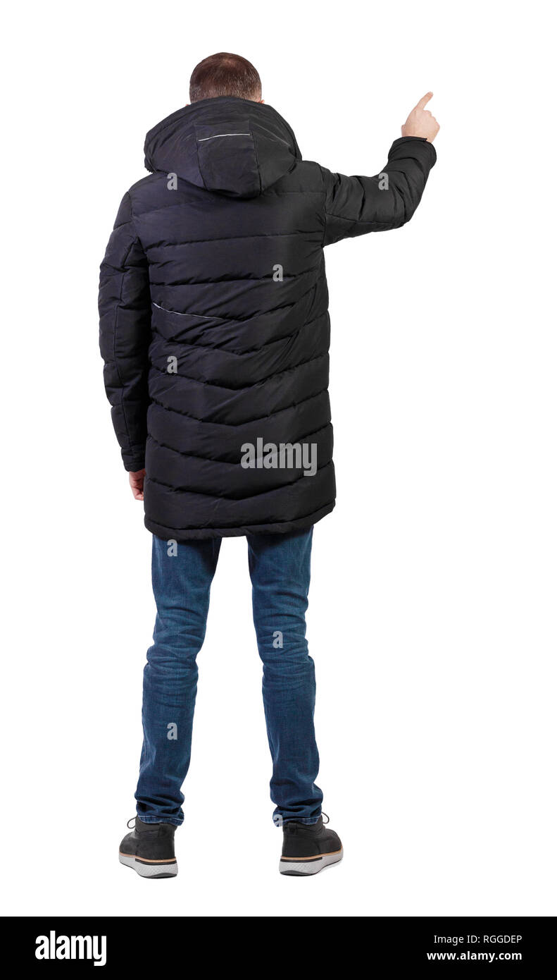 Back view of pointing young men in a black winter jacket. Young guy ...