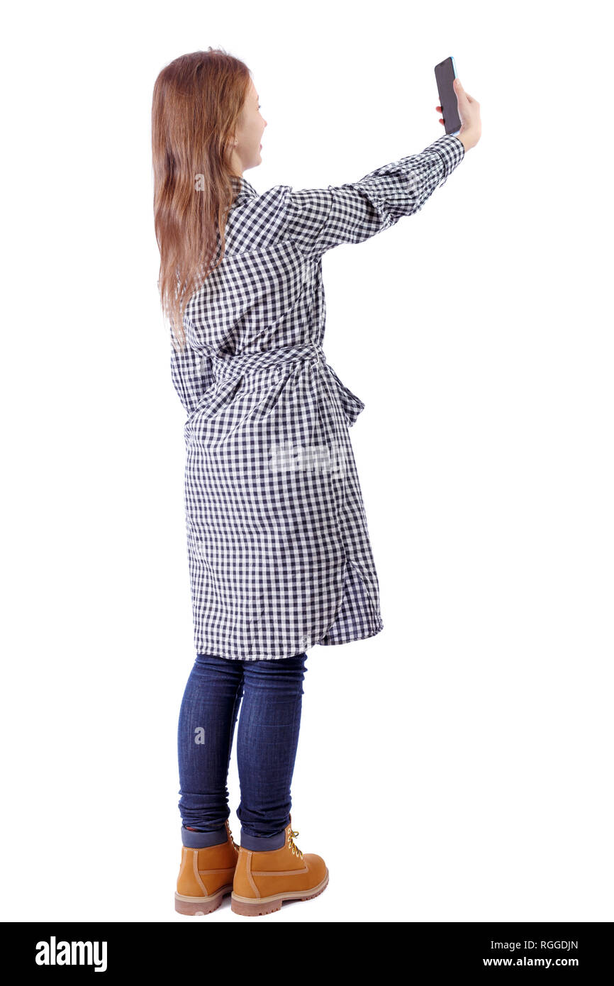 back view of standing young beautiful girl with tablet computer in the ...