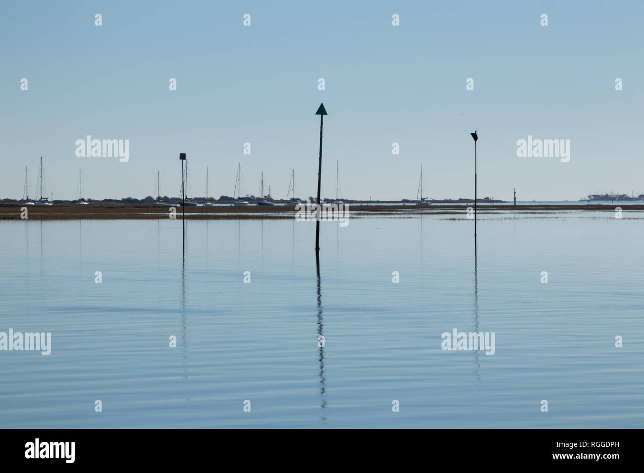 sea markers reflecting on calm blue water Stock Photo - Alamy