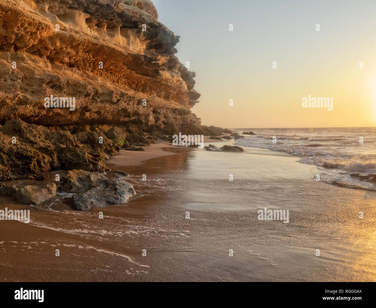 Beautiful sunset on the Namibe wild beach, Africa. Angola. With cliff ...