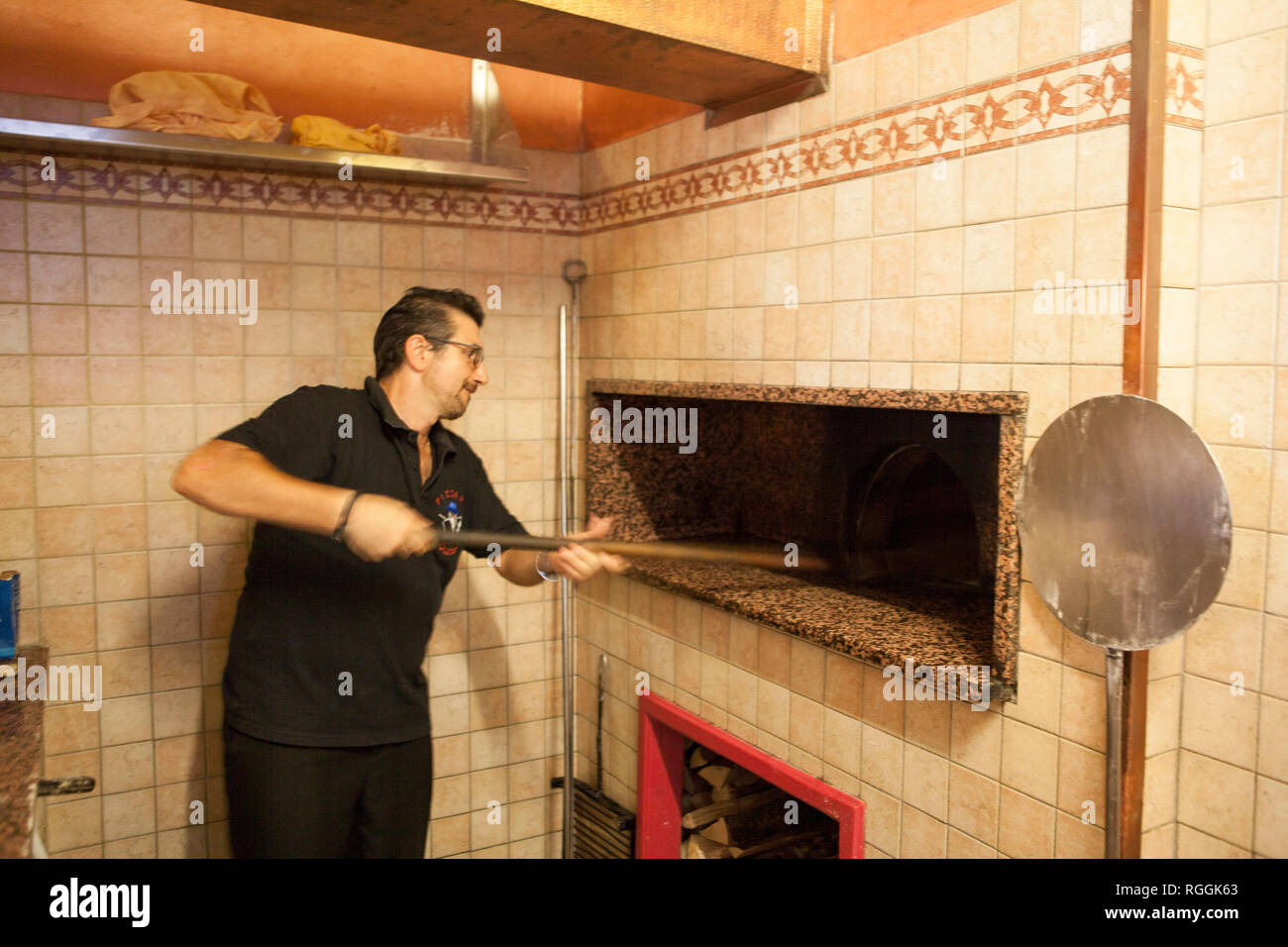 Man baking pizza, Alba, Italy Stock Photo - Alamy