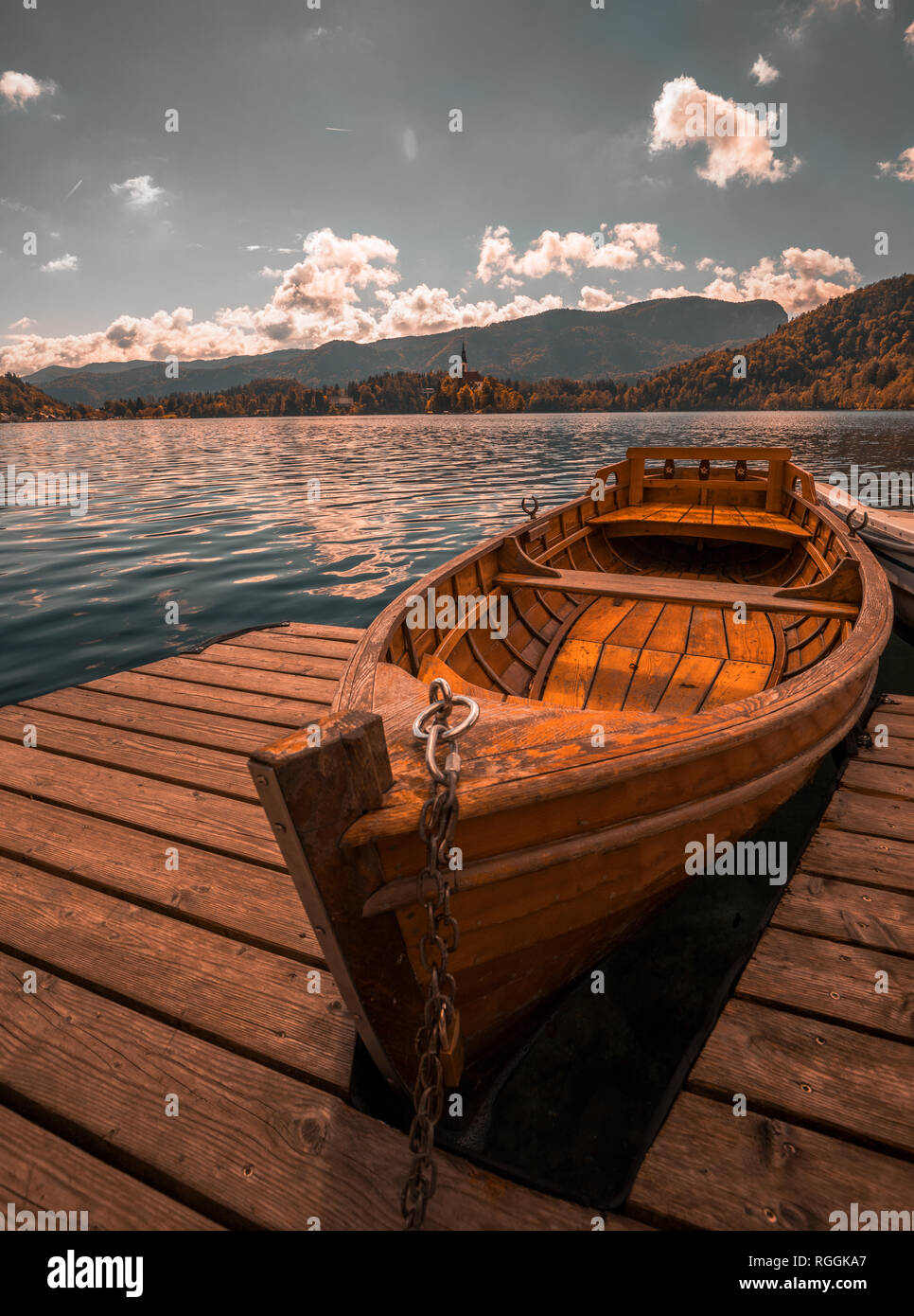 Traditional wooden boat Pletna on the backgorund of Church on the ...