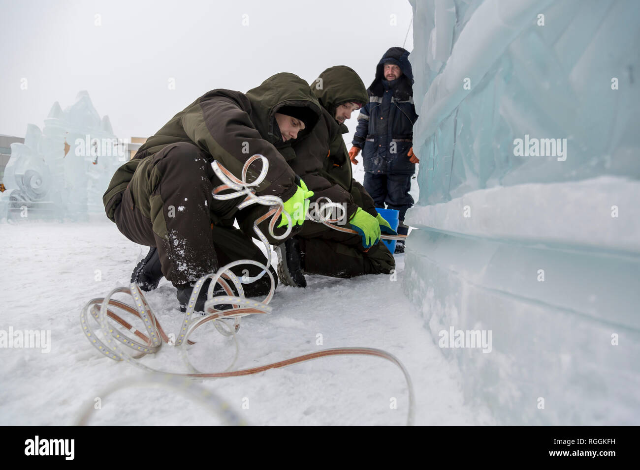 Electricians mount a power cable to illuminate ice figures Stock Photo ...