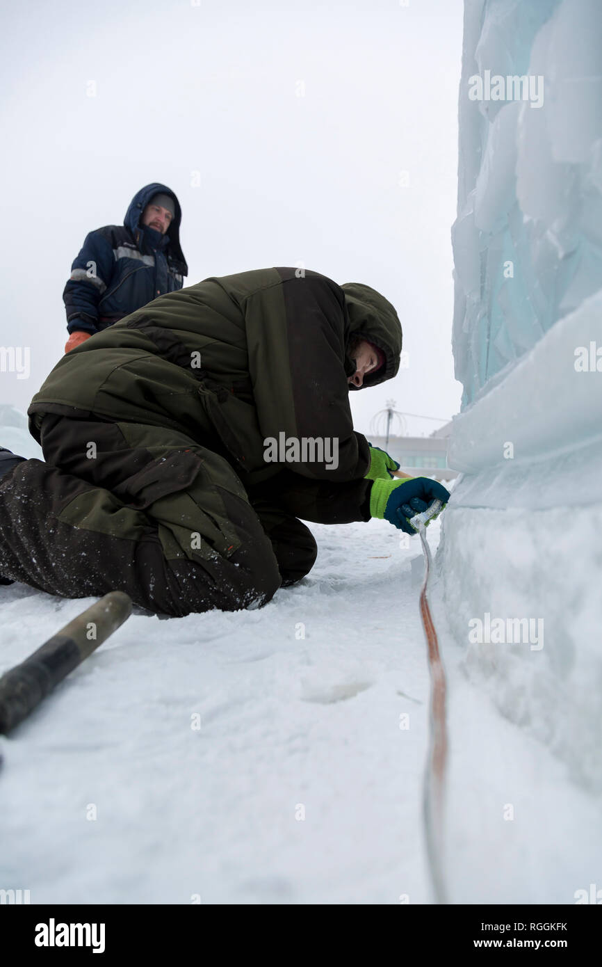 Electricians mount a power cable to illuminate ice figures Stock Photo ...