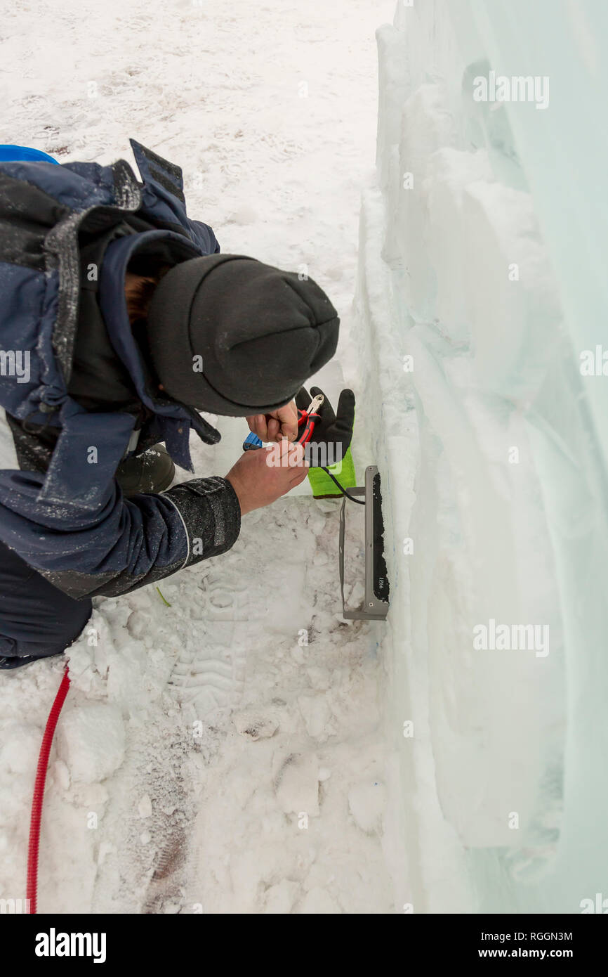 Electrician mounts LED flashlight to illuminate the ice figure Stock ...