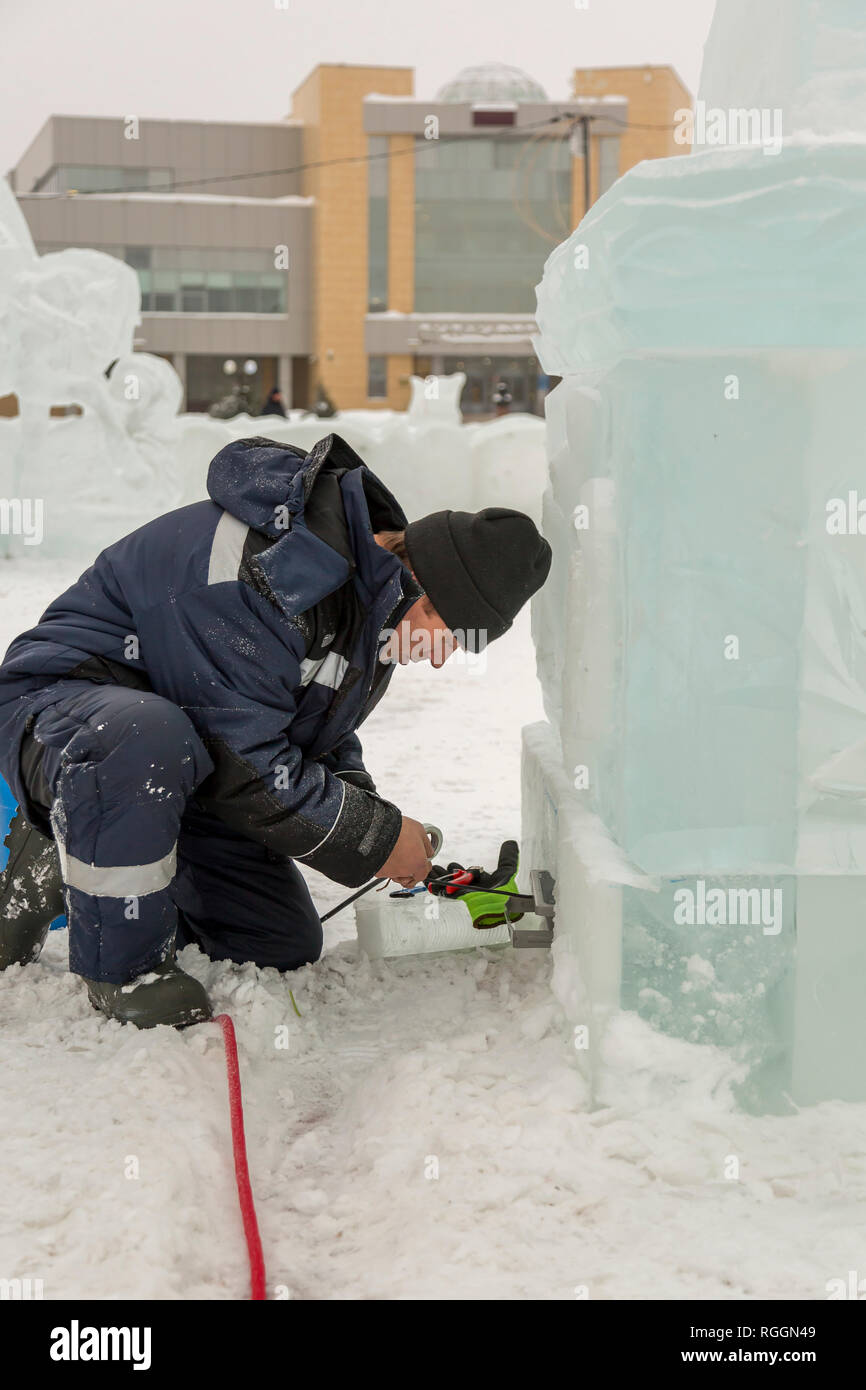 Electrician mounts LED flashlight to illuminate the ice figure Stock ...