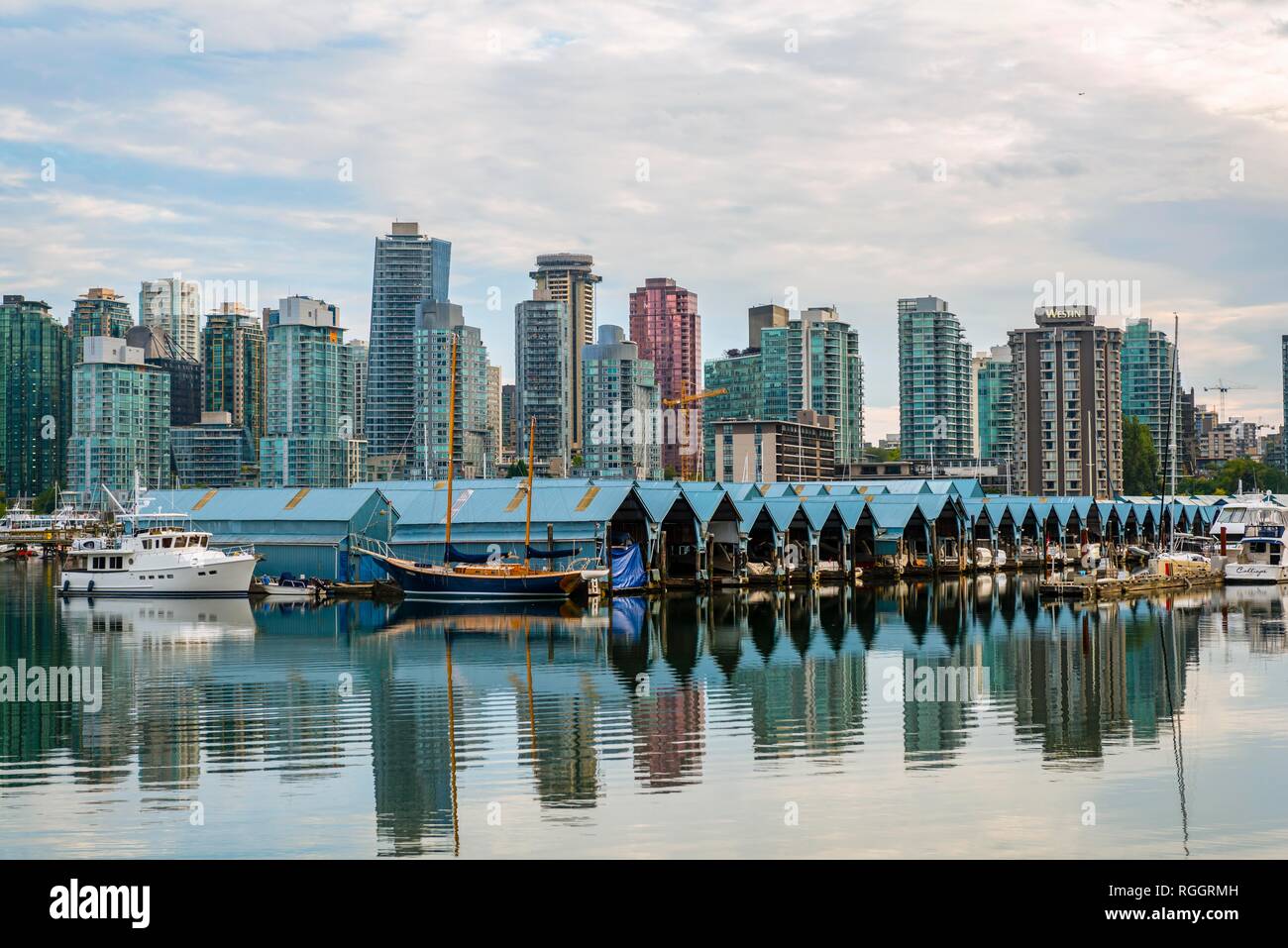 Skyscrapers and sailboats in the marina, skyline of Vancouver reflected ...