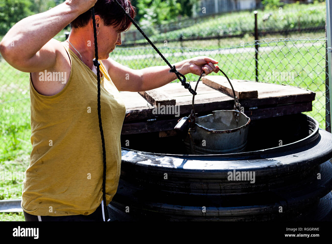 Woman fetching water and plant hi-res stock photography and images - Alamy