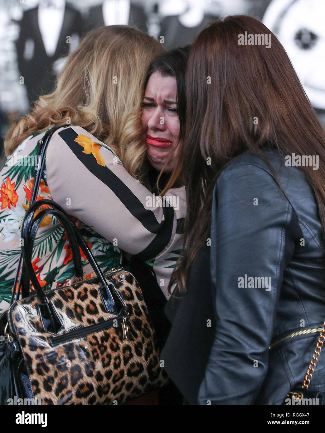 Laura Plummer (centre) is embraced by her sisters Lynda (left) and ...