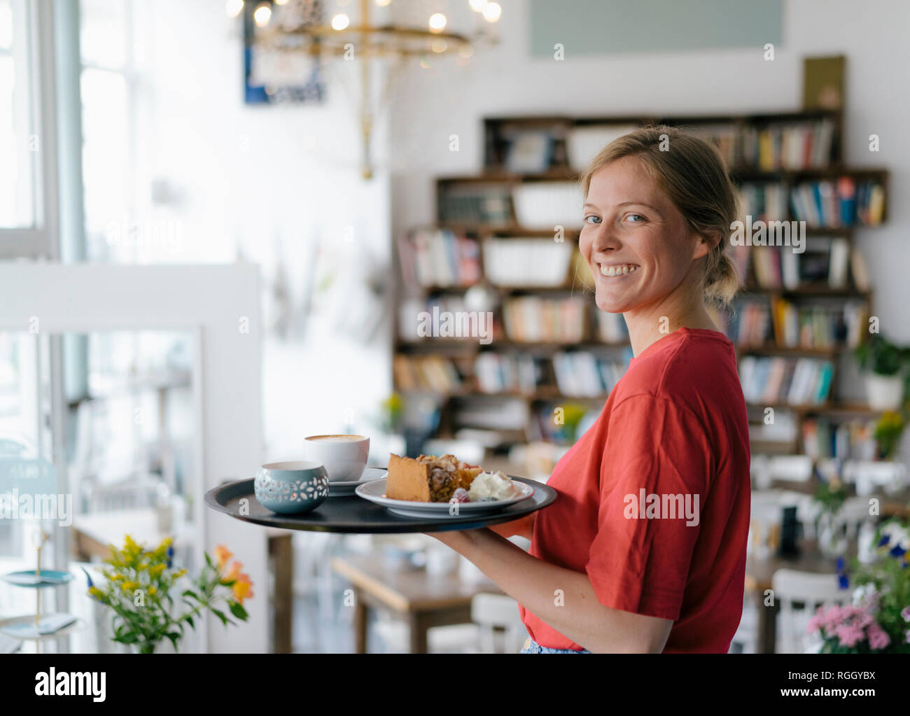 Portrait smiling young woman serving coffee cafe hi-res stock ...