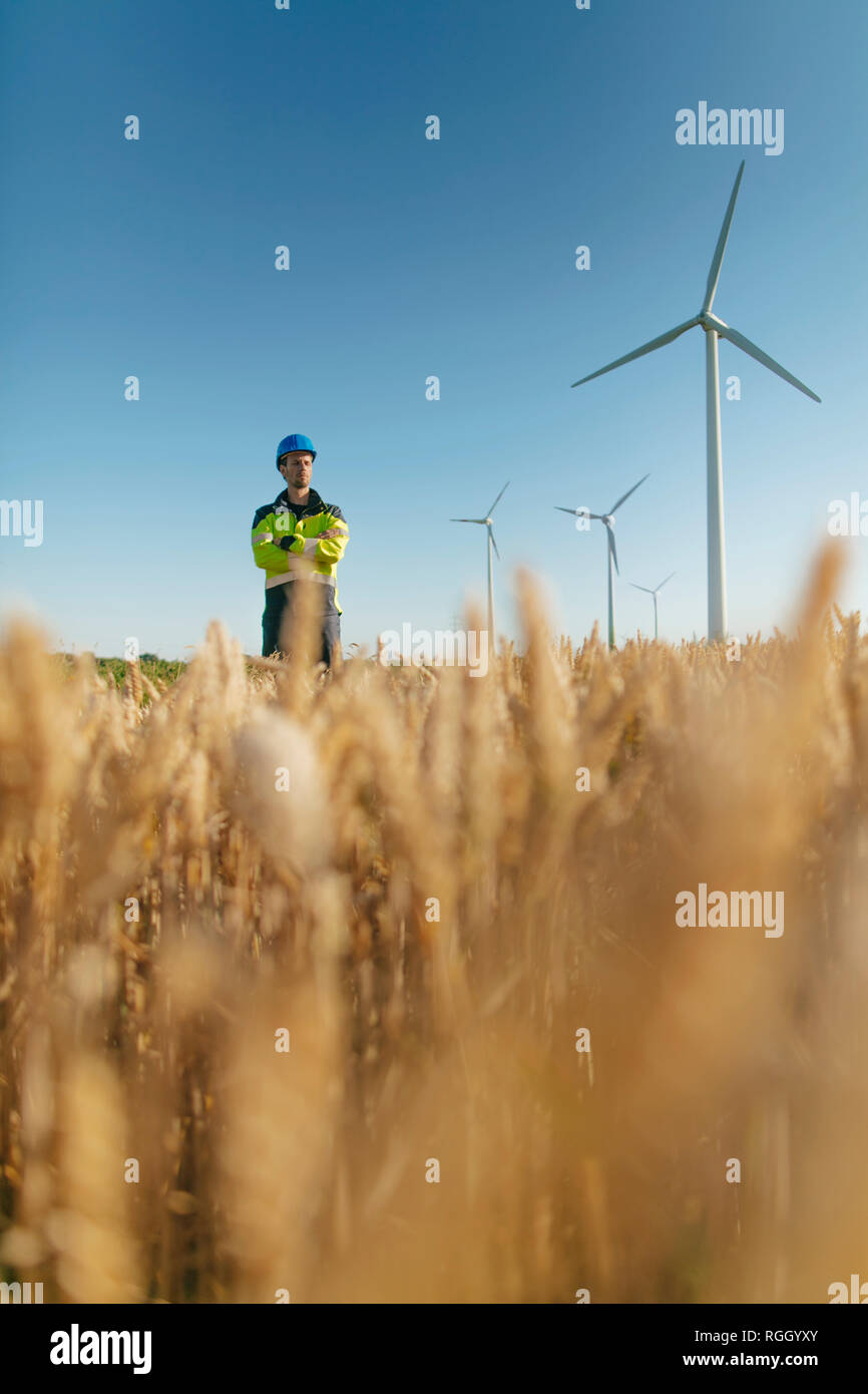 Engineer standing in a field at a wind farm Stock Photo - Alamy