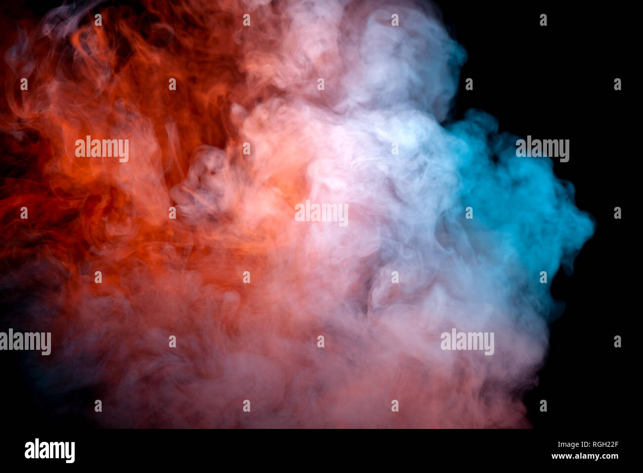 A dense, swirling cloud of colorful smoke against a black background ...