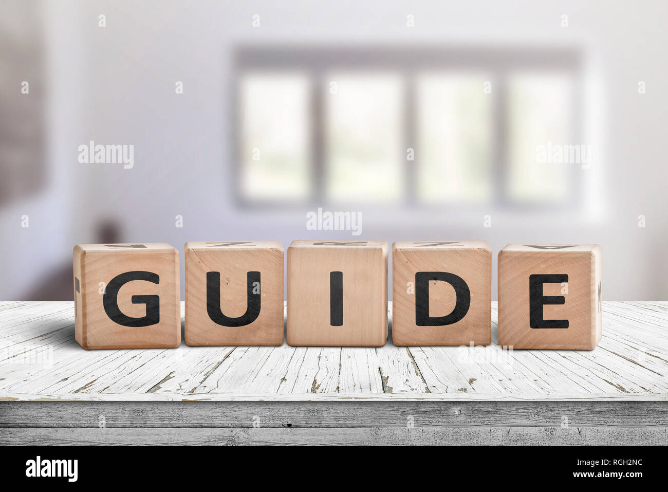 Guide sign made of wood on a desk in a bright room with windows Stock ...