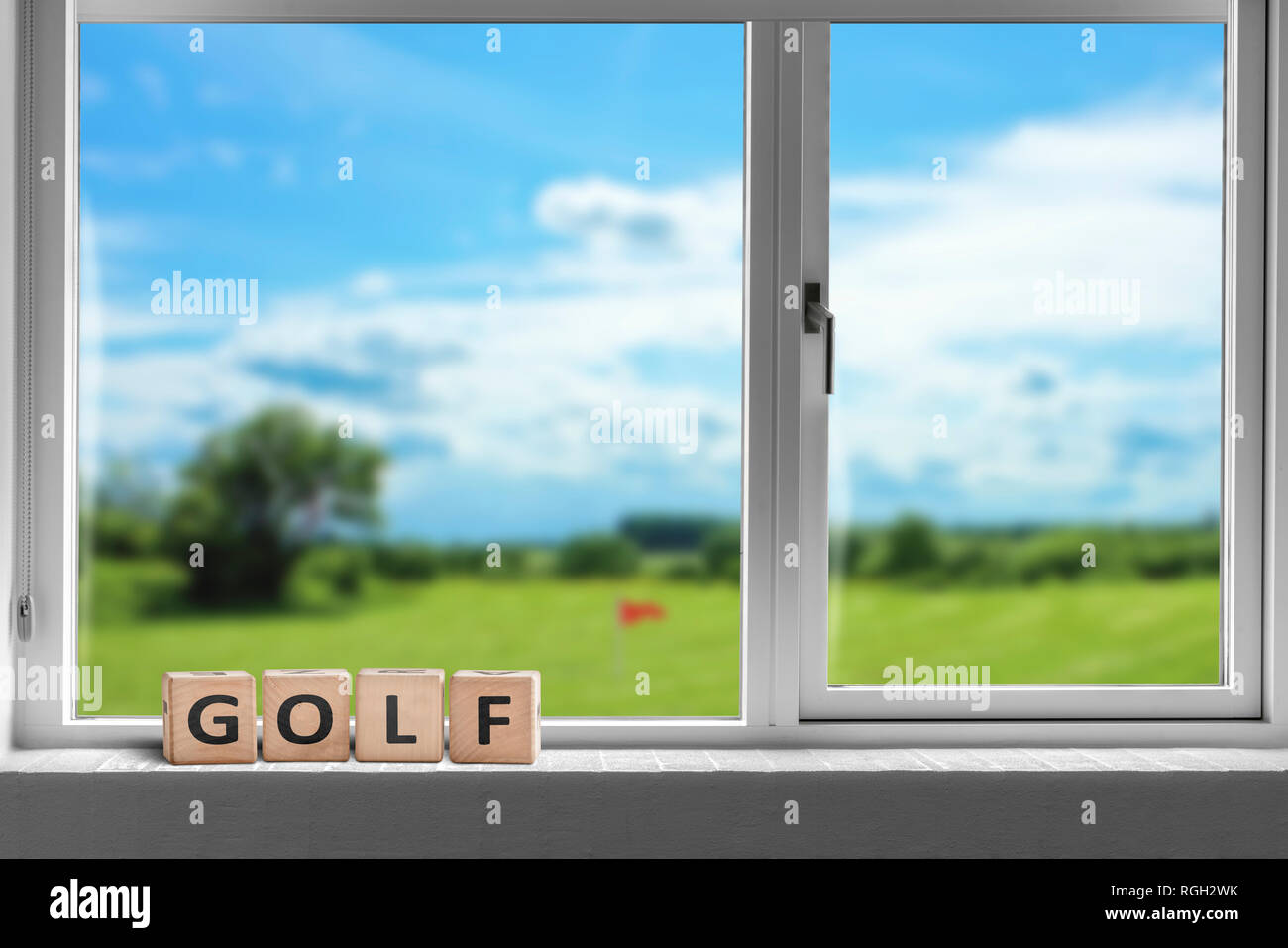 Golf sign in a window with a view to a golf course in bright daylight ...