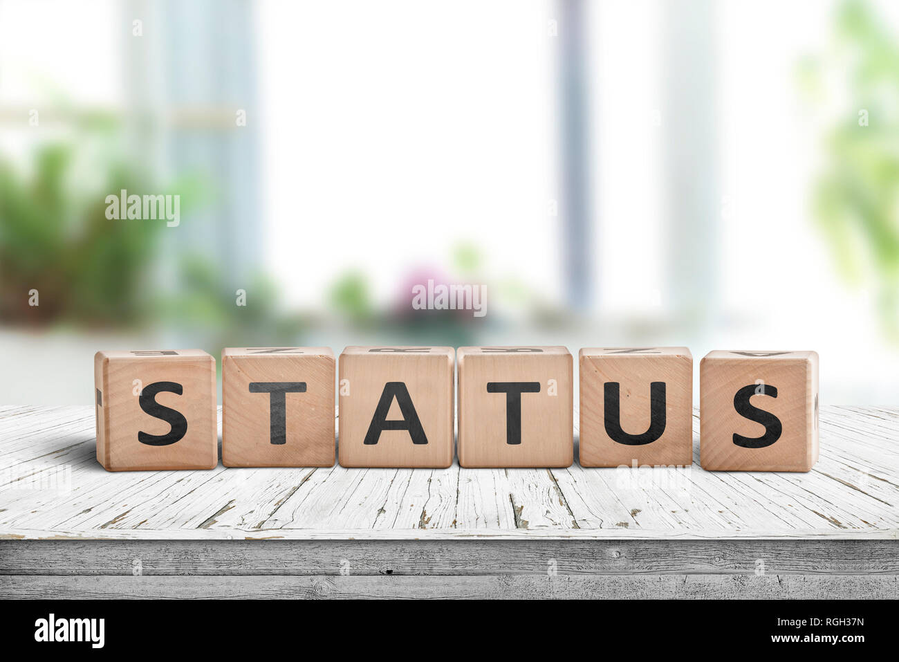 Status sign made of wood on a table in a bright room Stock Photo - Alamy
