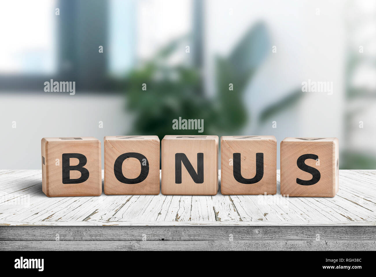 Bonus reward sign on a white table in a bright office with green plants ...