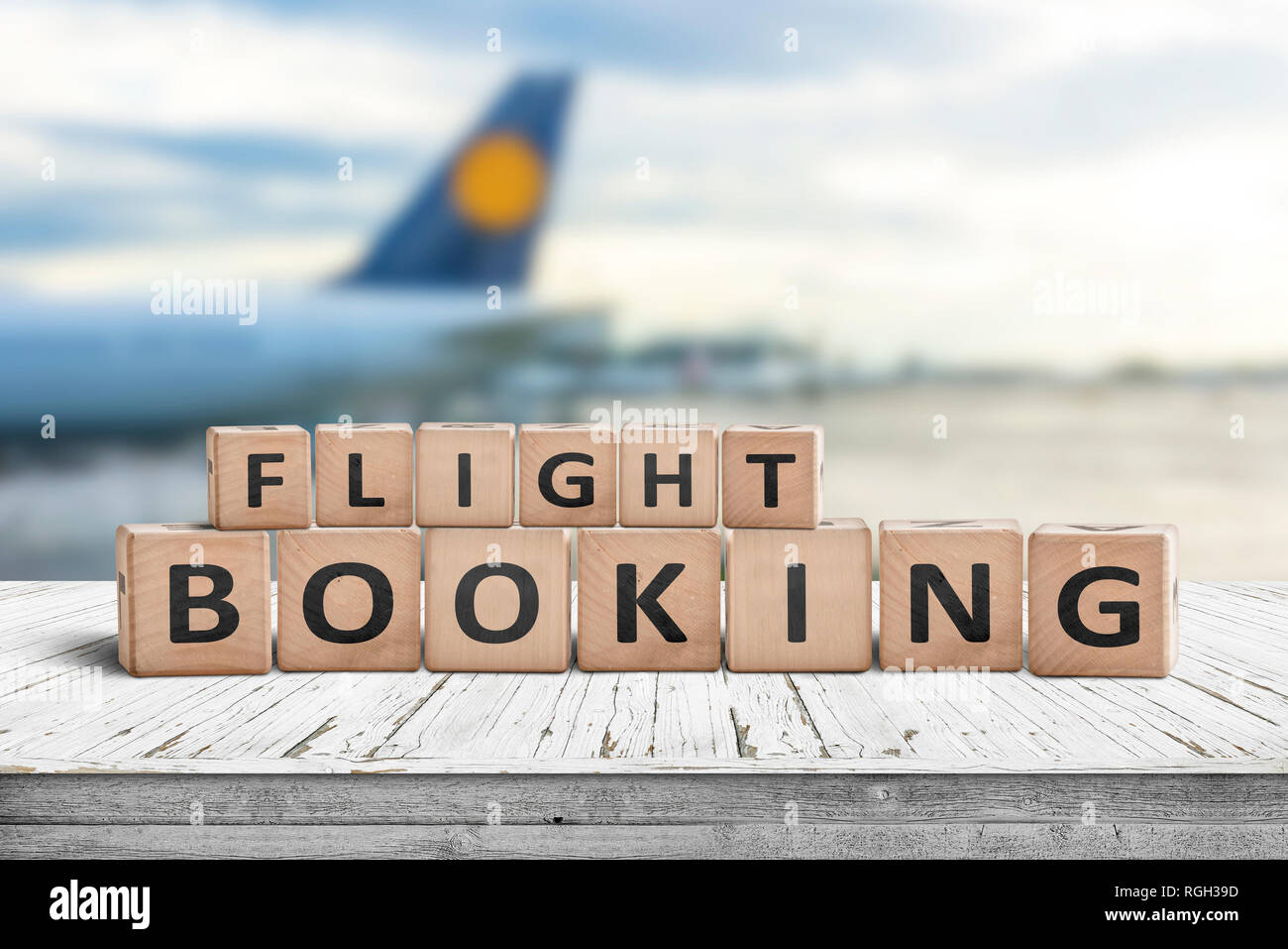 Flight booking sign at an airport with a plane in the background Stock ...