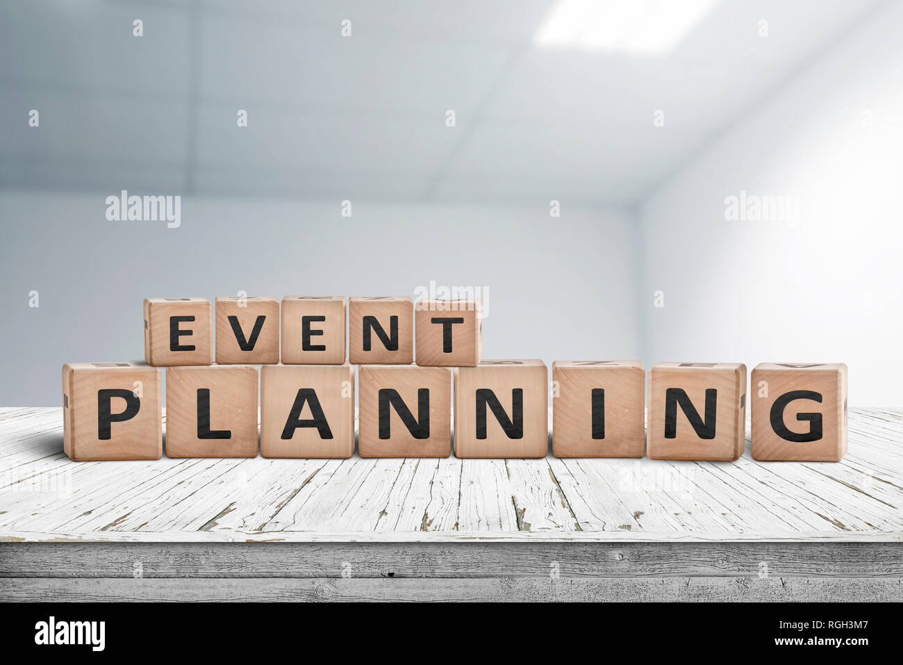 Event planning sign on a wooden desk in an office with a blurry grey ...