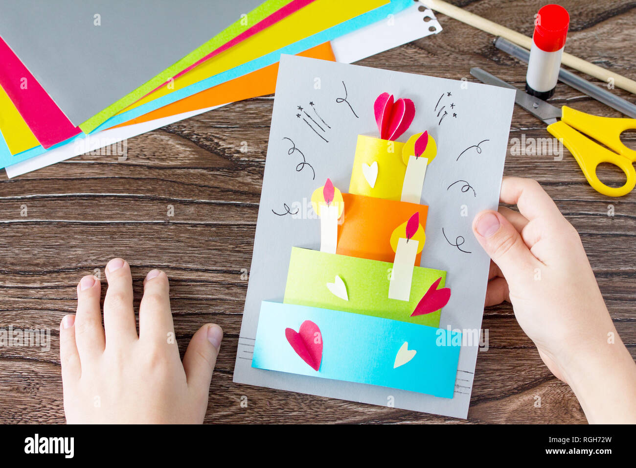 The child holds Greeting card with birthday cake congratulation ...