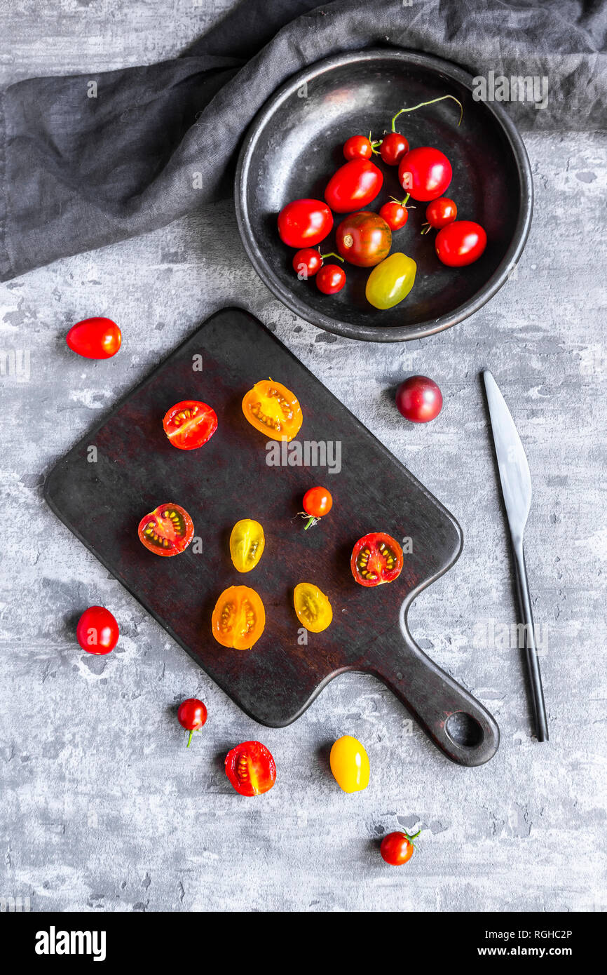Whole and sliced mini tomatoes Stock Photo - Alamy