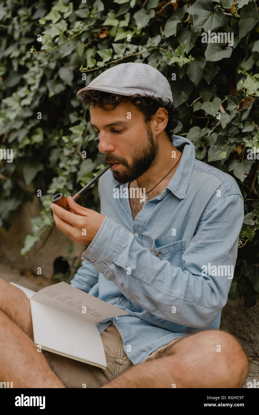Young man smoking pipe hi-res stock photography and images - Alamy