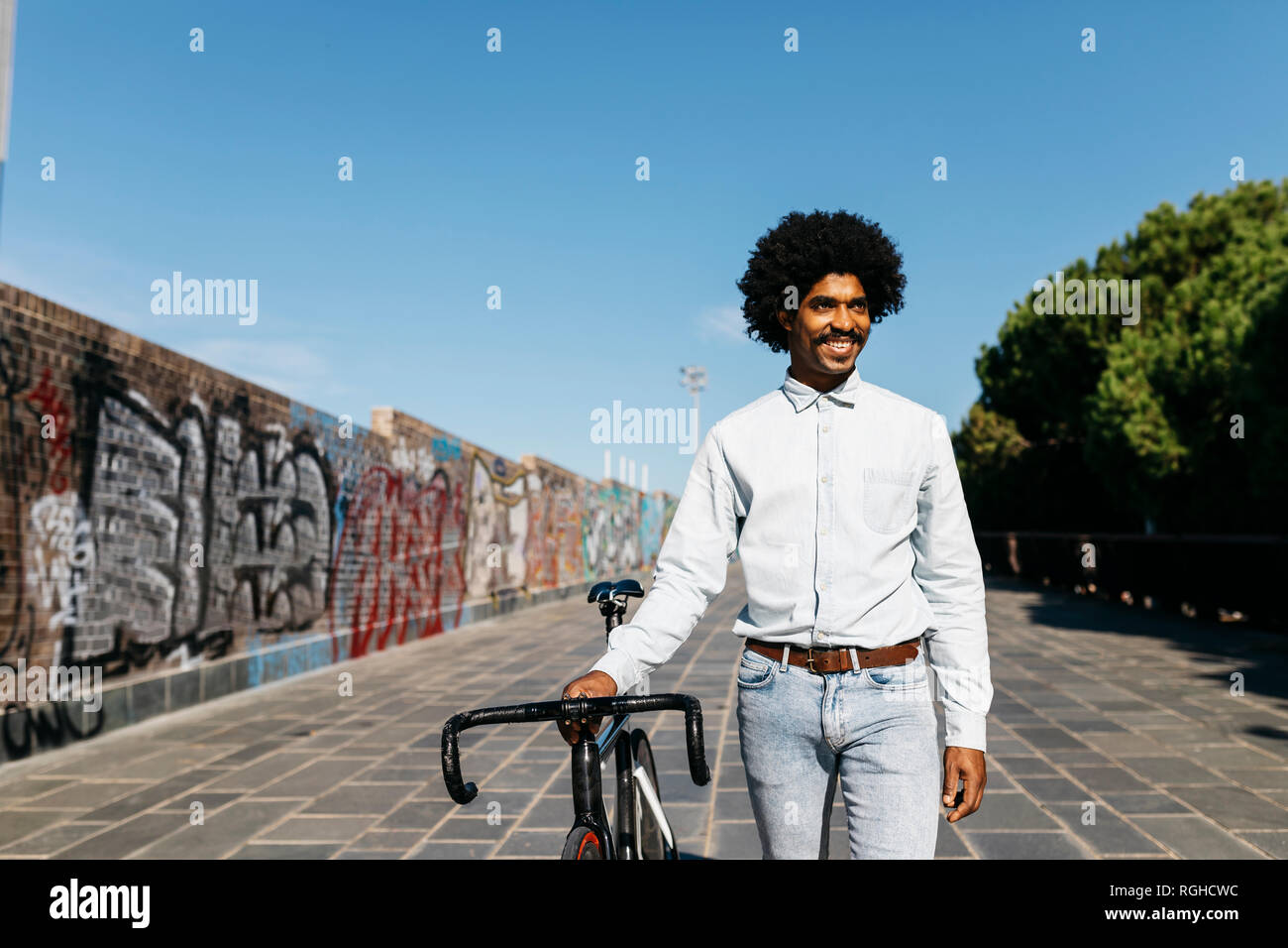 Man pushing his bicycle hi-res stock photography and images - Alamy