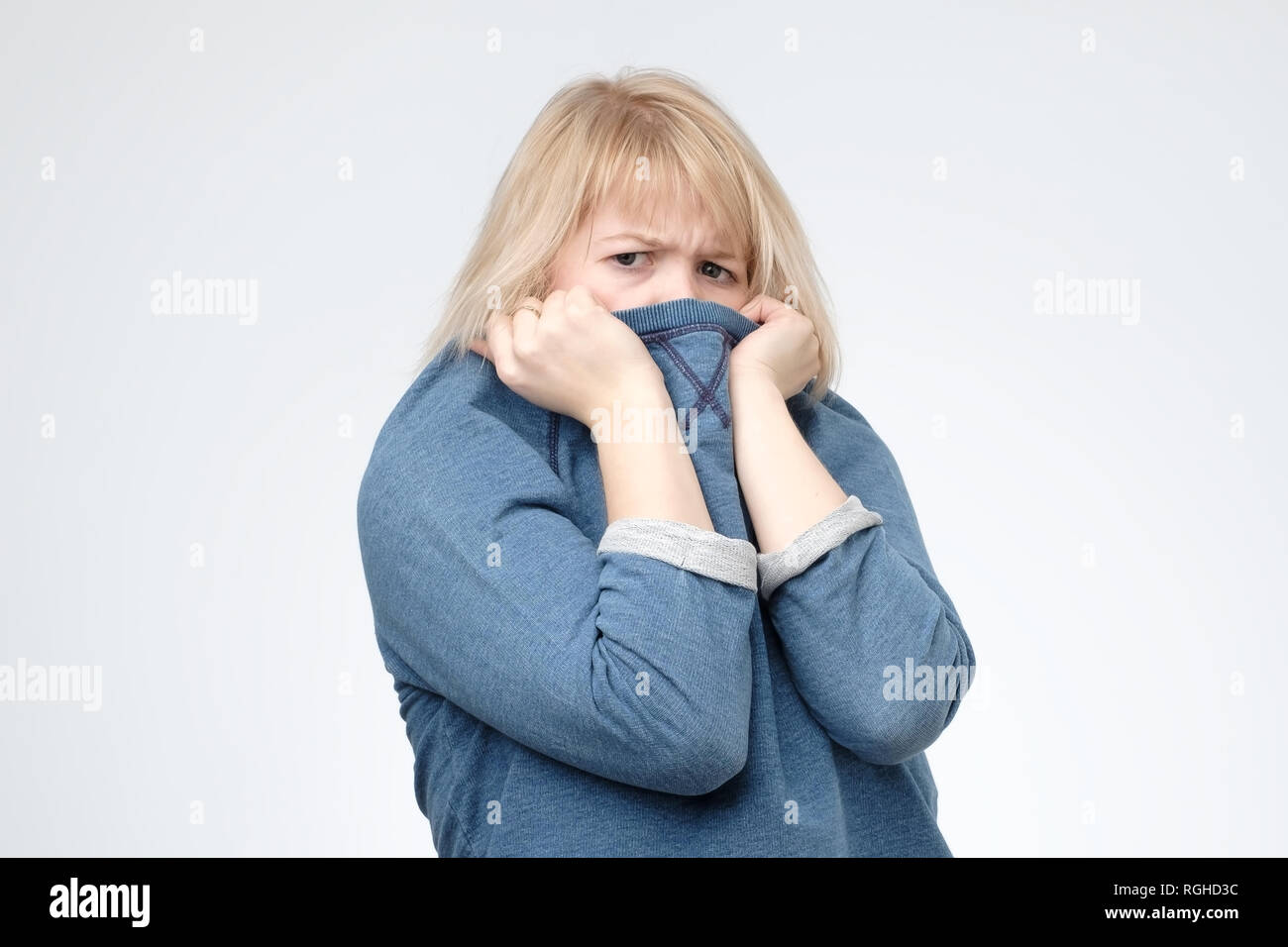 Woman pulling sweater over face hi-res stock photography and images - Alamy