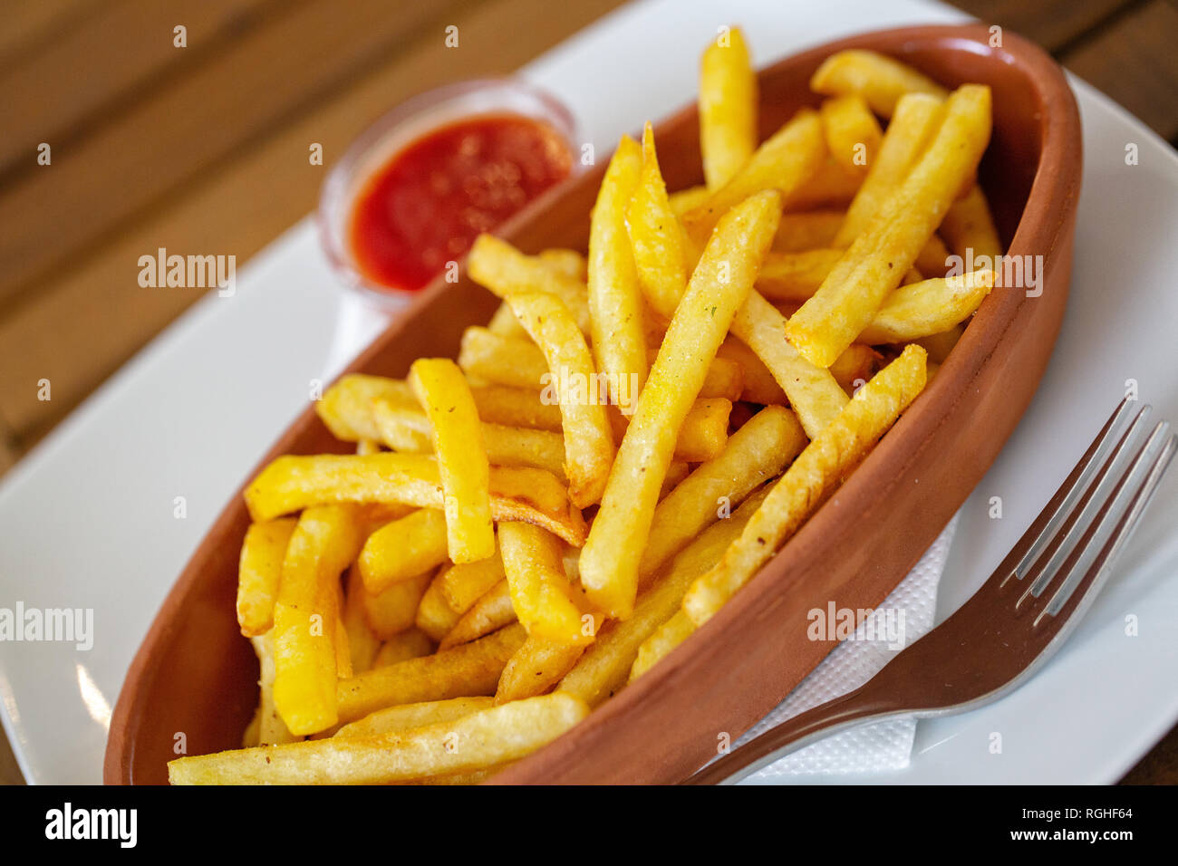 Oval clay plate of french fries on a wooden table, top view Stock Photo ...
