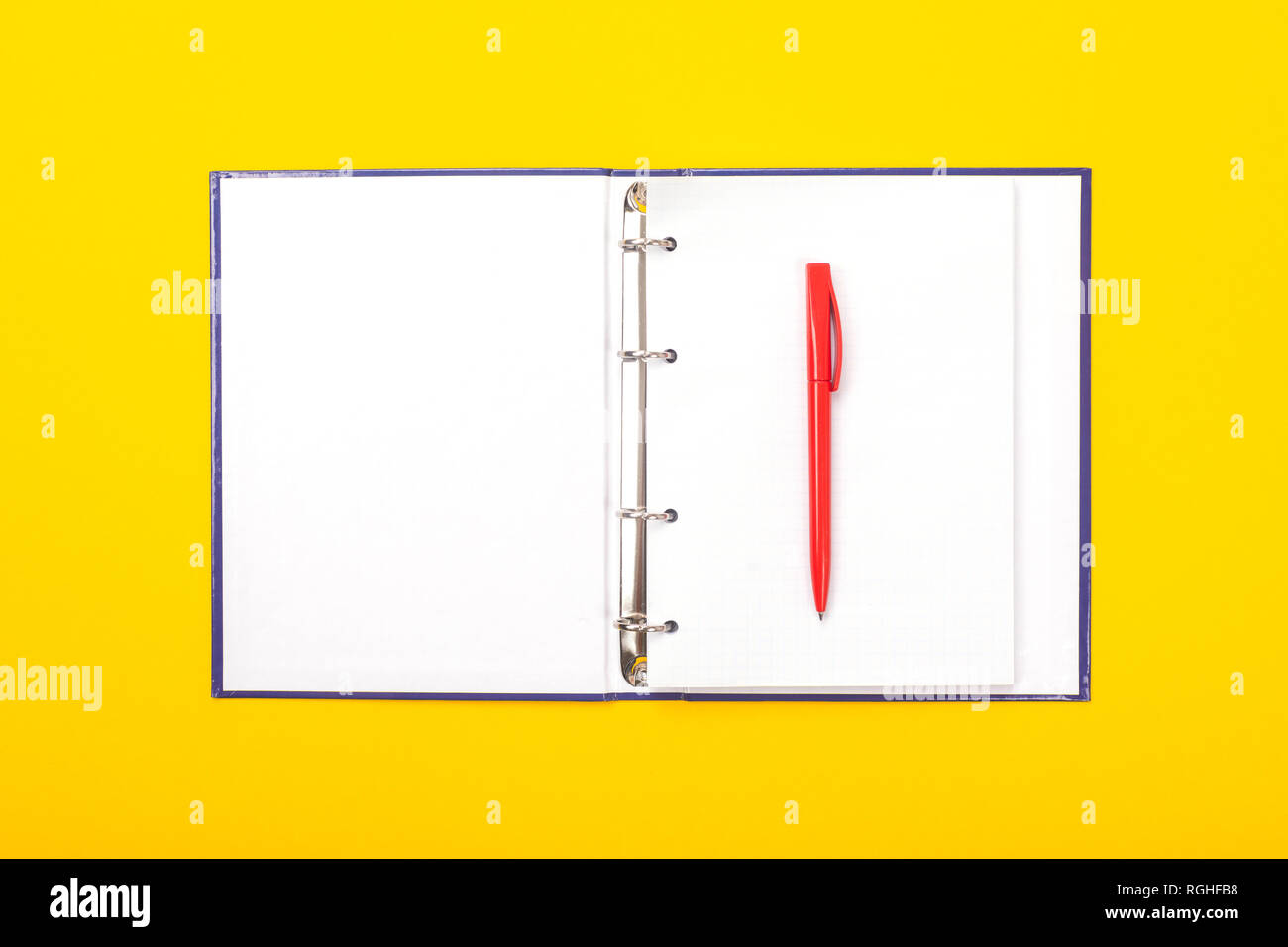 Top view of an Open Notepad on rings with clean sheets and a ballpoint ...