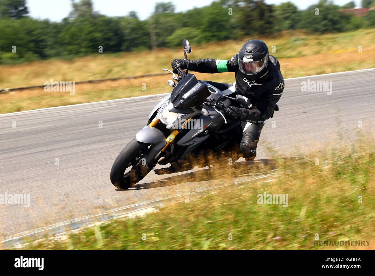 A man leaning over his bike in a curve on a circuit Stock Photo - Alamy