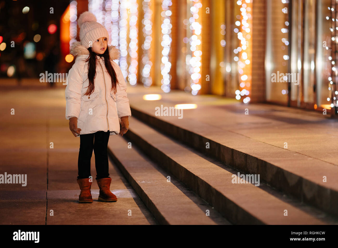 Cute happy little girl walks on the streets of a big city Stock Photo ...