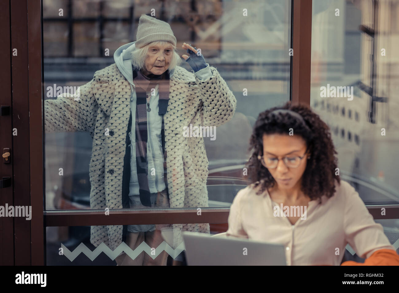 Sad depressed woman standing behind the window Stock Photo - Alamy