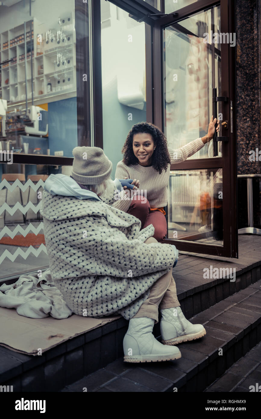 Joyful young woman being friendly to people Stock Photo - Alamy