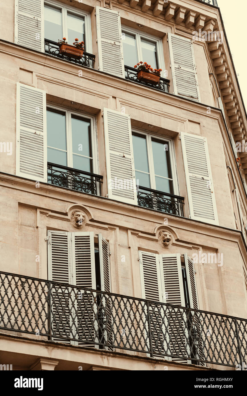 View from below on windows on a facade European building in Paris ...