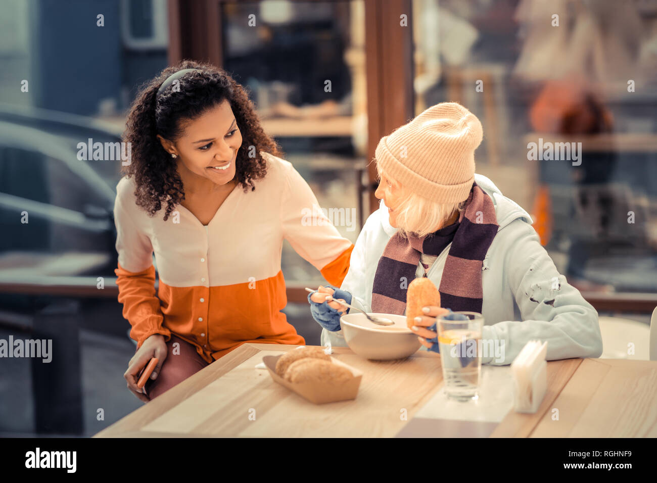 Nice joyful woman helping poor homeless people Stock Photo - Alamy