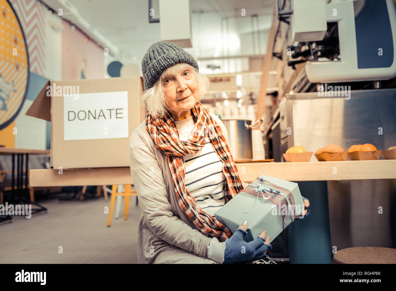 Nice joyful homeless woman receiving a gift Stock Photo - Alamy