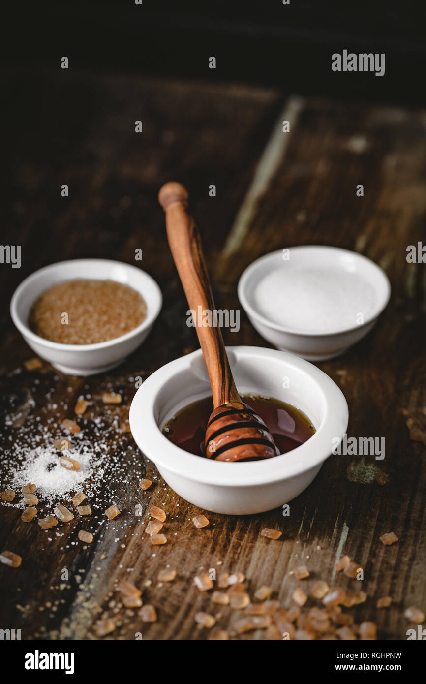 different kinds of sugar and maple syrup on a dark background Stock ...